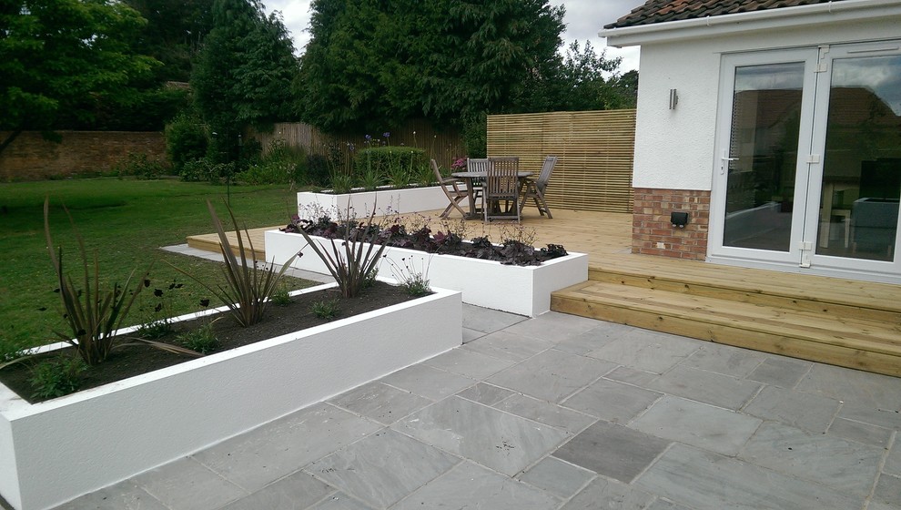 Contemporary softwood decking and rendered raised beds - Contemporary ...