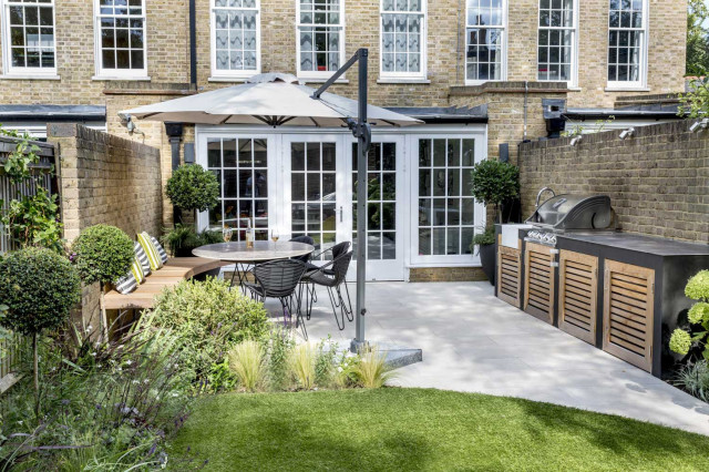 Natural stone patio with dining area and outdoor kitchen - Contemporary ...