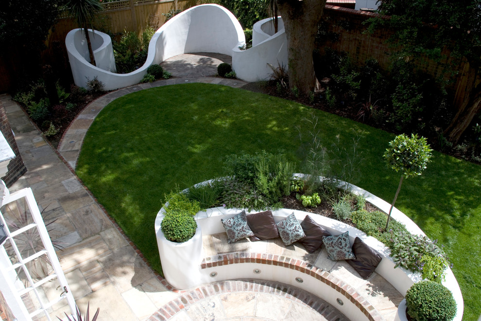 Swirling rendered wall and semi-circle rendered seating and raised bed ...