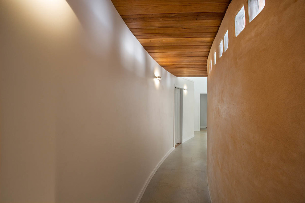 Curved cob wall, concrete floor, timber ceiling - Contemporary - Hall ...