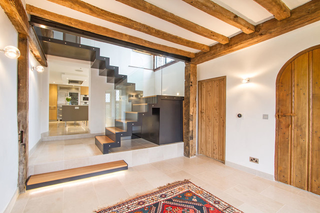 Restored hallway featuring bespoke contemporary staircase ...