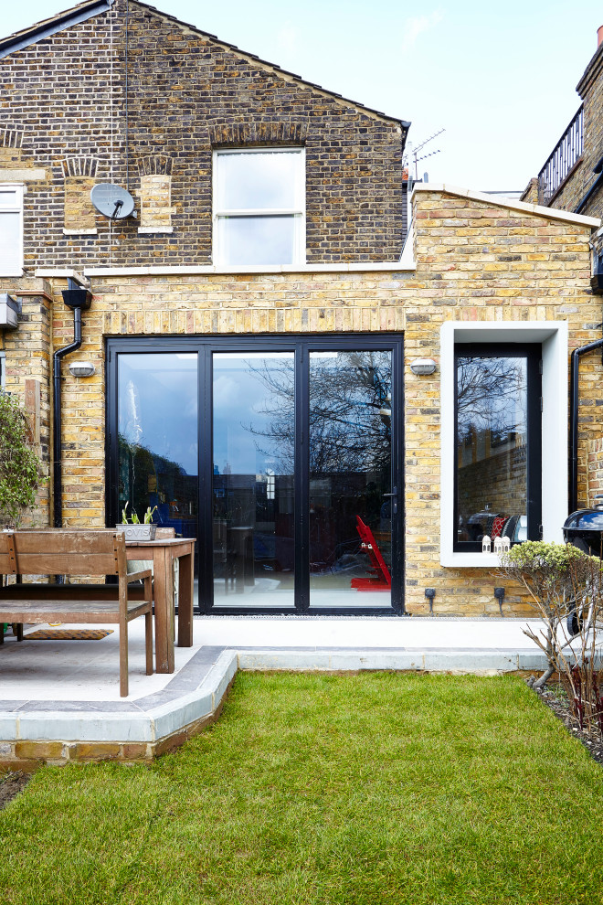 Rear extension with closed bi-fold door and concrete decking - Exterior ...