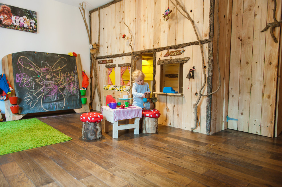 Indoor forest cottage playroom with giant blackboard and rustic storage ...