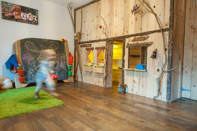Indoor forest cottage playroom with giant blackboard and rustic storage ...