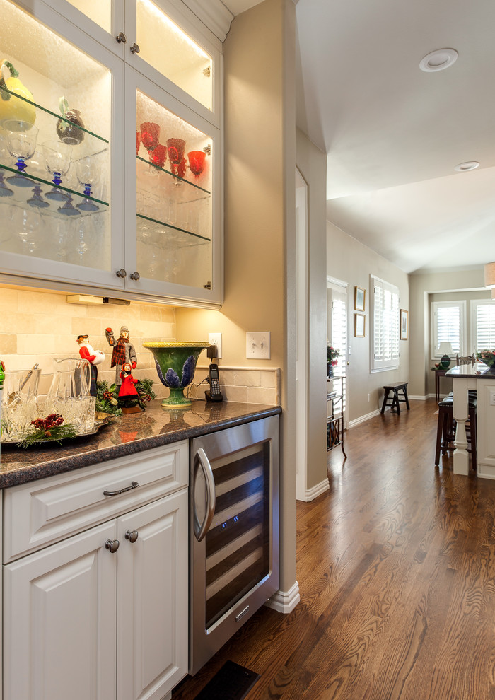 Adjoining butlers pantry with open shelving and wine refrigerator ...