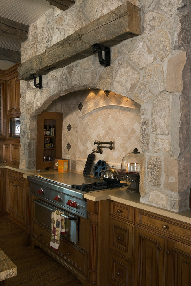 Arch top stone range top surround, reclaimed barn beam, and recessed ...