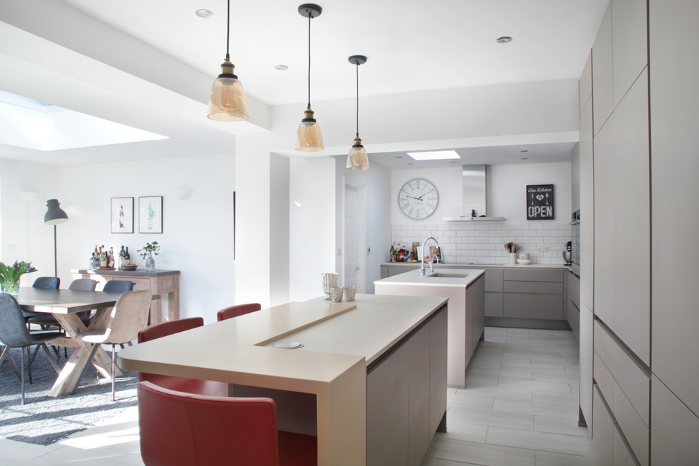Contemporary handleless kitchen in classic colours with two islands ...