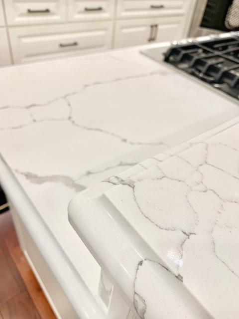 Ivory White Kitchen With Marble Look Quartz Counters and Splash ...