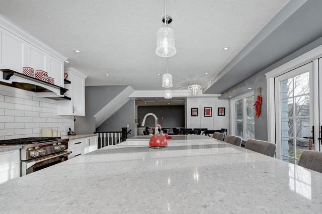 Kitchen island showing custom hood shroud and floating stained maple ...