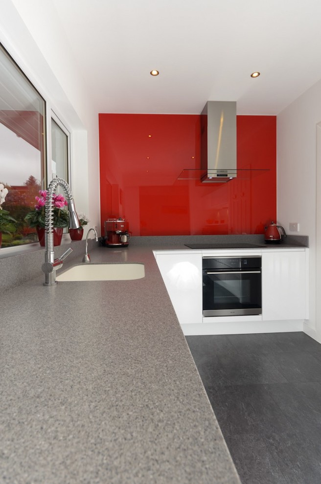 Modern white kitchen with accent red splashback - Contemporary ...