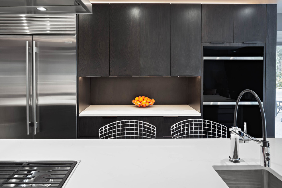 Solid wood slab doors blend seamlessly with this stainless and black ...