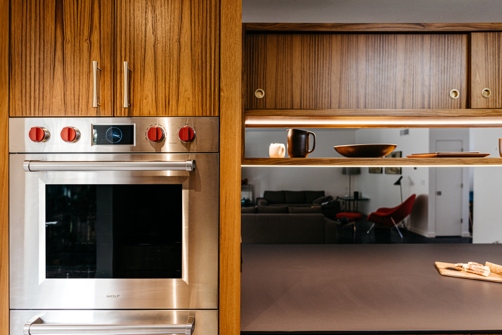 Stacked Stainless Steel Ovens and Teak Cabinets in Kitchen Peninsula ...