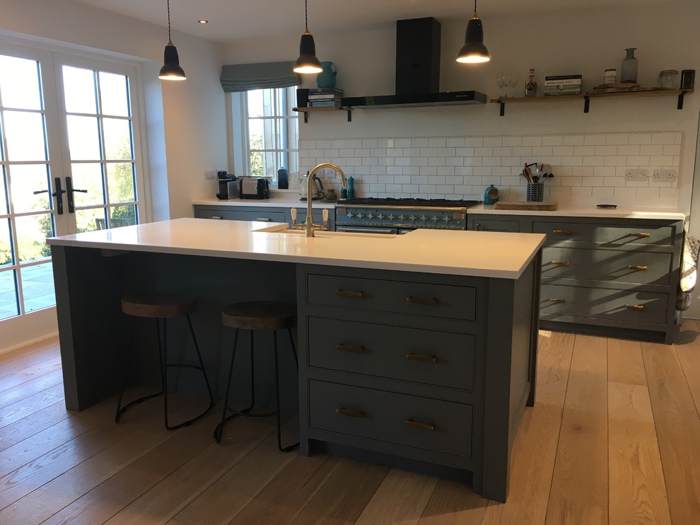 Stunning blue kitchen with island and built-in breakfast bar - Modern ...