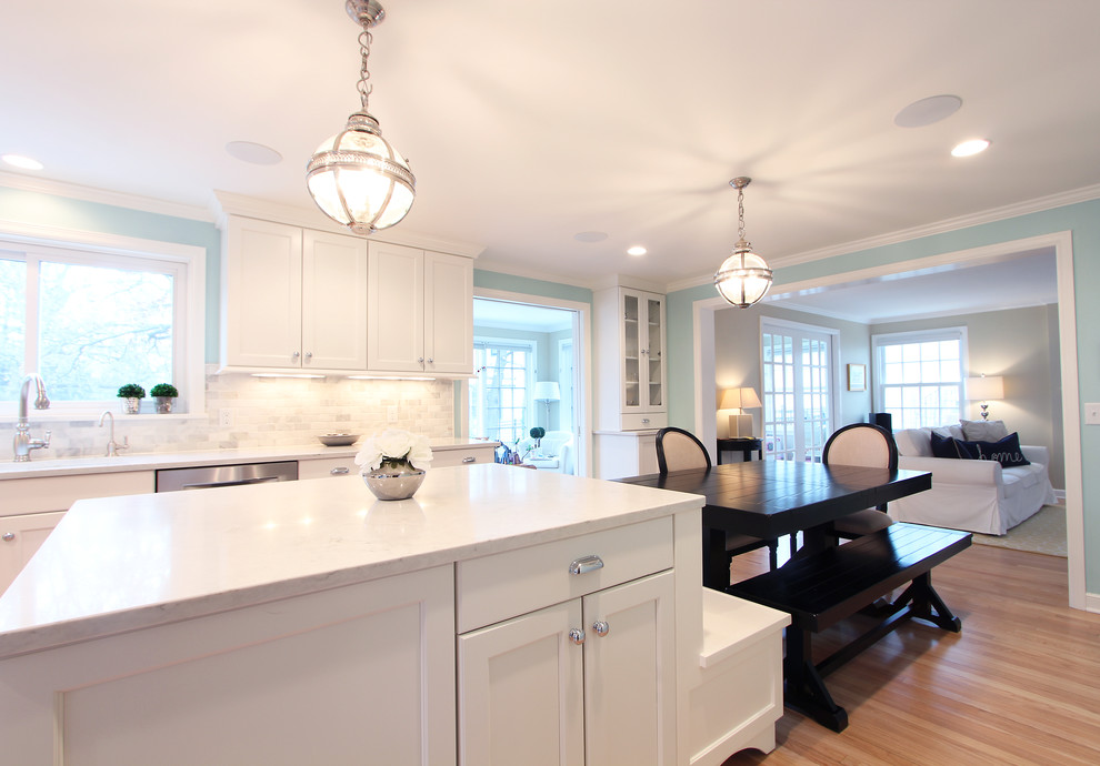 Table Seating Off Kitchen Island with White Cabinets - Transitional ...