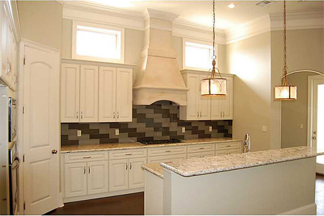 This custom kitchen offers granite countertops with a ceramic tile ...