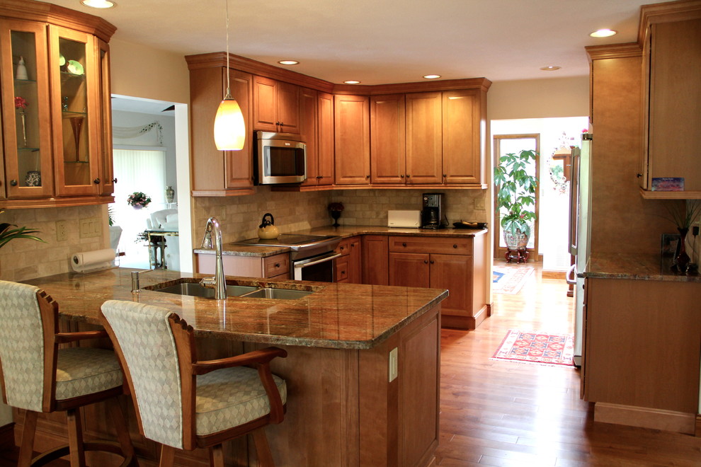 View of whole kitchen featuring peninsula, l-shaped corner and straight ...