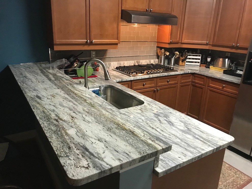 Welcoming, traditional design kitchen in "Thunder White" granite ...