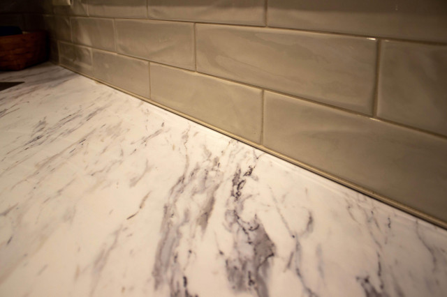 White Kitchen with Calcutta Marble Laminate Countertop and Tile ...