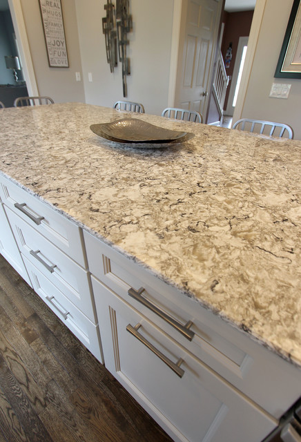 White Kitchen with Gray and Black Quartz Countertop and Bar Area ...