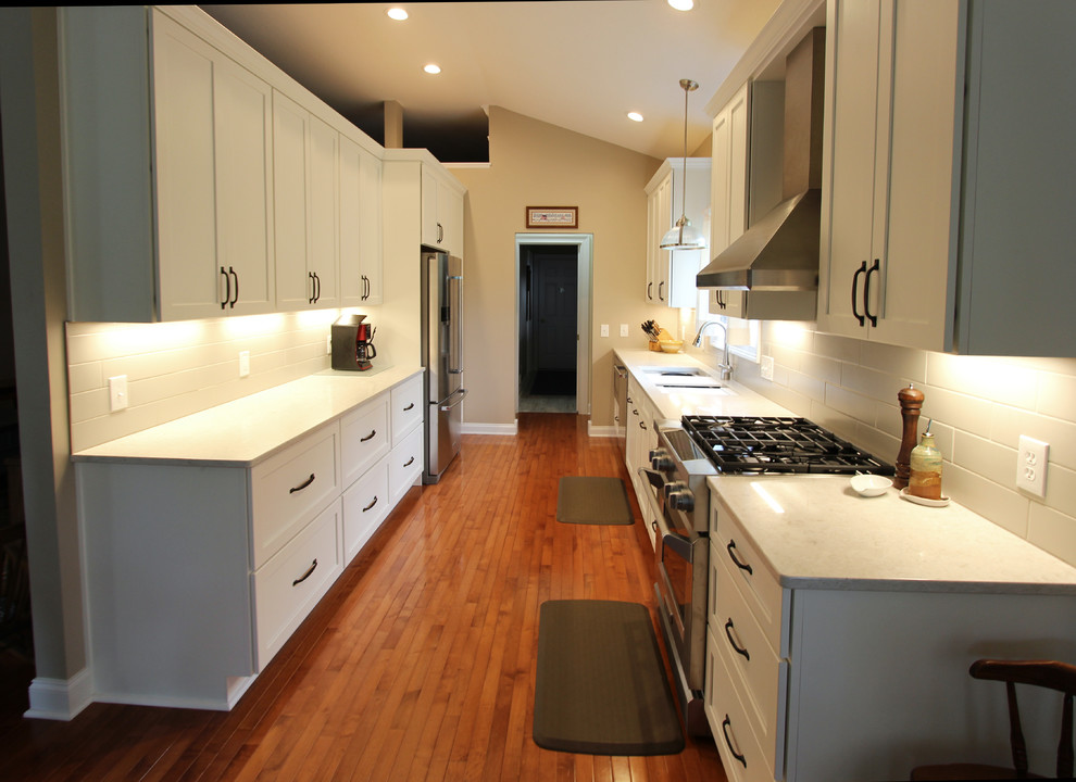 White Kitchen with Quartz Countertop, Galley Workstation and Large ...