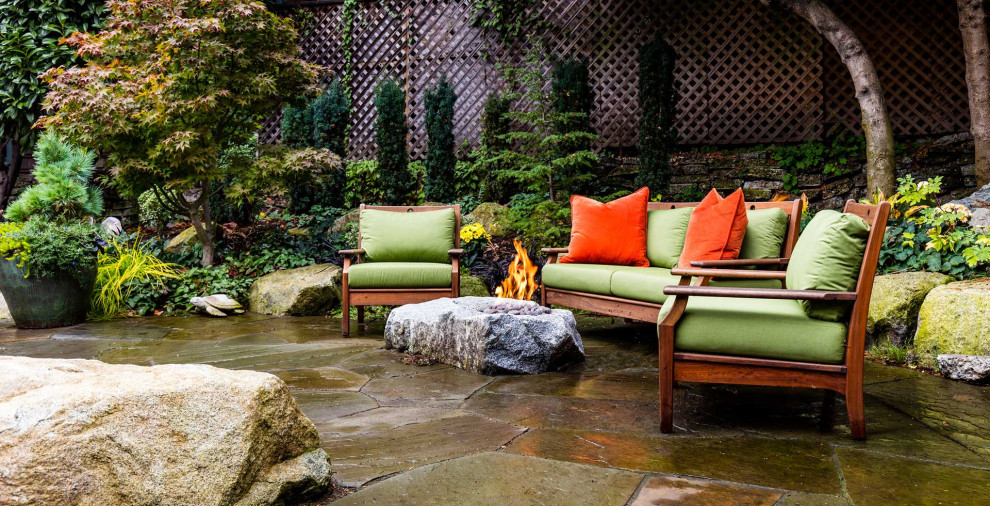 A Cozy Garden for Outdoor Living Amongst Stone and Greenery ...
