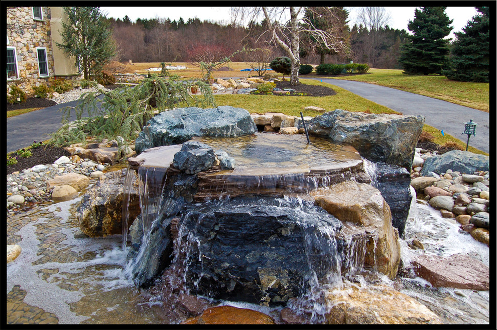 A pondless waterfall or recirculating fountain adds drama to a home ...