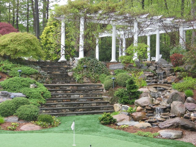 Backyard terraces with a waterfall staircase and pergola - Traditional ...