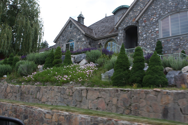 Home with Cobblestone Retaining Wall Side View - Traditional - Garden ...