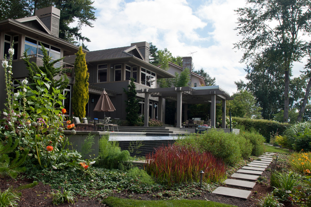 Infinity pool surrounded by colorful plants - Traditional - Landscape ...