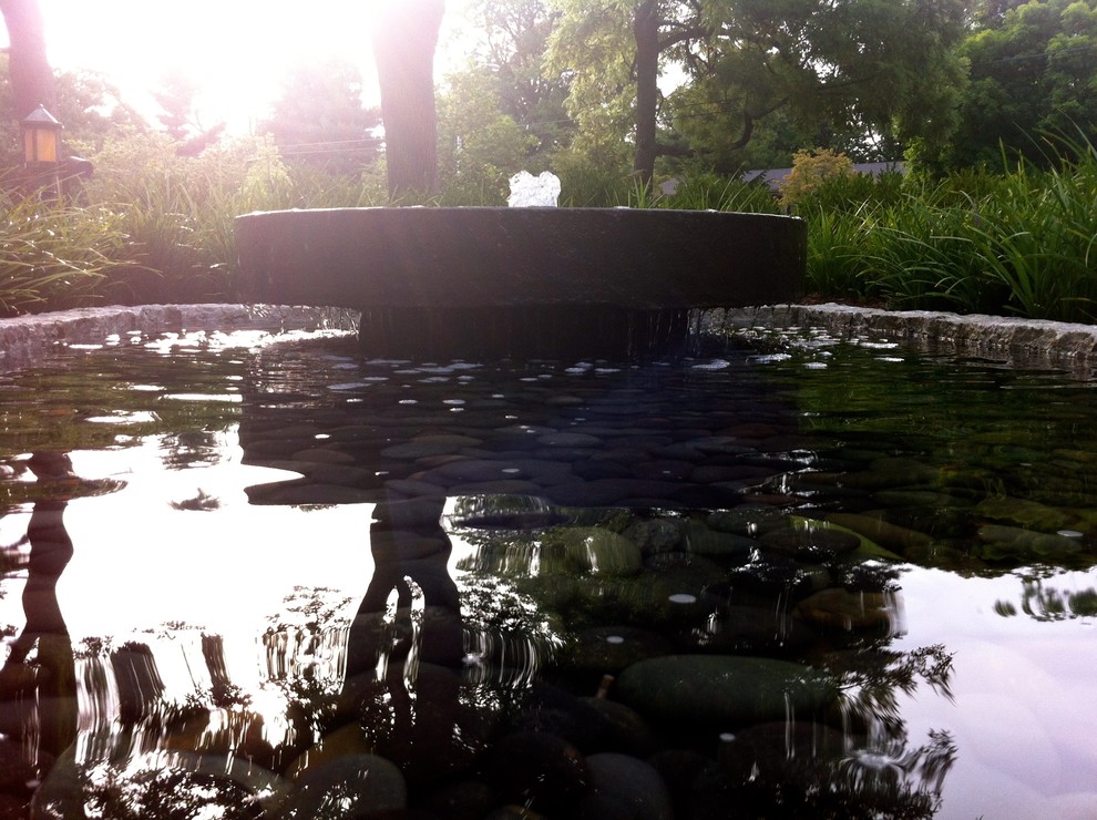 Millstone water feature with Mexican beach pebbles just below water ...