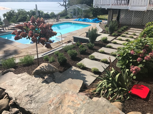 Natural antique bluestone wall with plantings and bluestone steppers ...