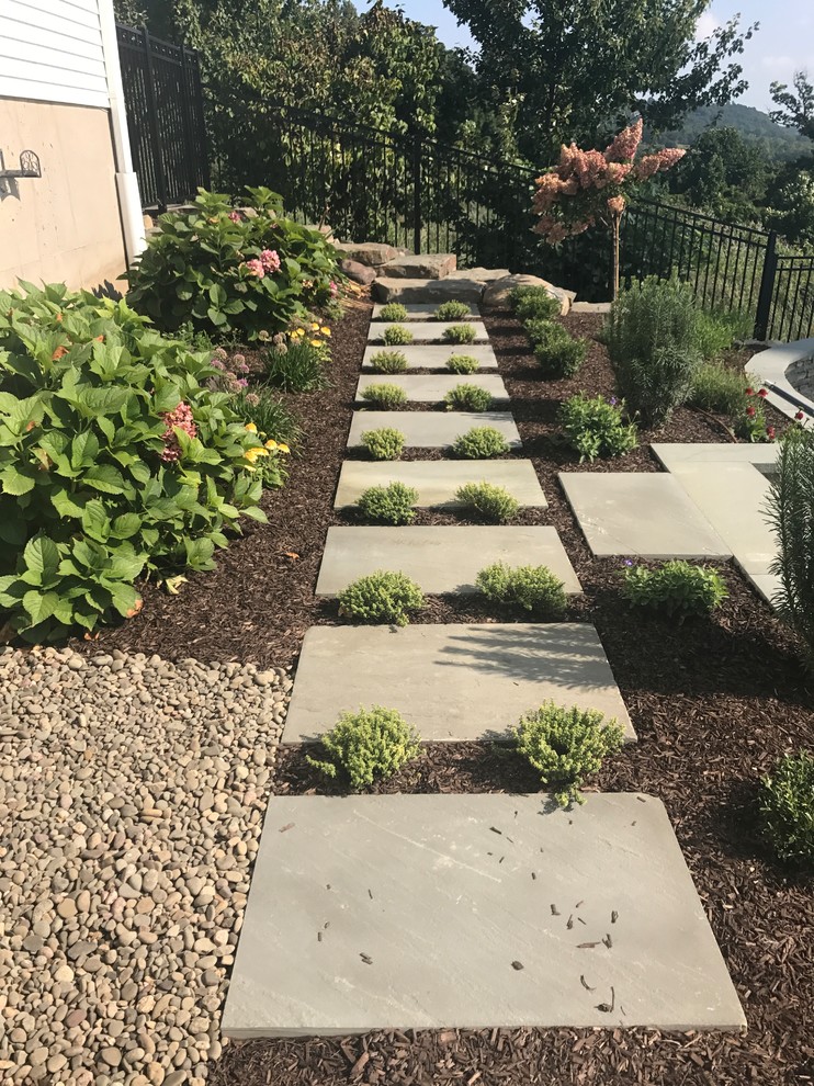 Natural antique bluestone wall with plantings and bluestone steppers ...