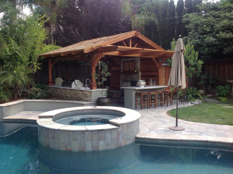 Outdoor kitchen with custom wood roof, granite countertops, and paver ...