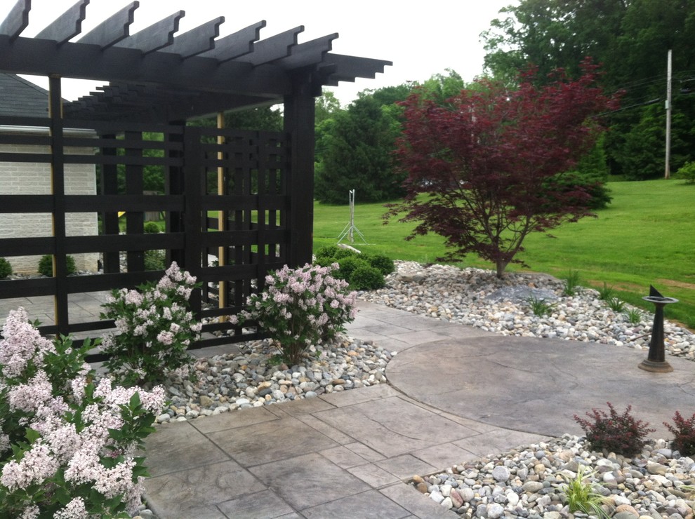 stamped concrete walkway and privacy courtyard with shade structure ...