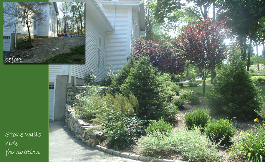 Stone retaining walls and plantings hide house foundation. Evergreen ...