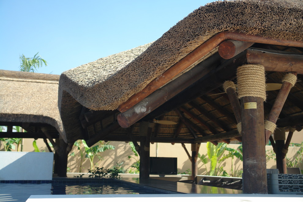 Thatch & timber is the is the focal point of this beautifully landscaped garden - Contemporary ...