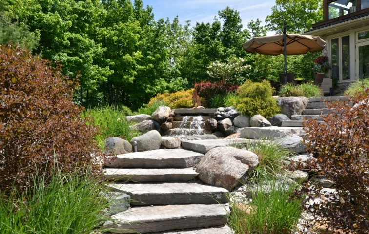 Water fall travered by slab steps & boulder retaining - Rustic - Garden ...