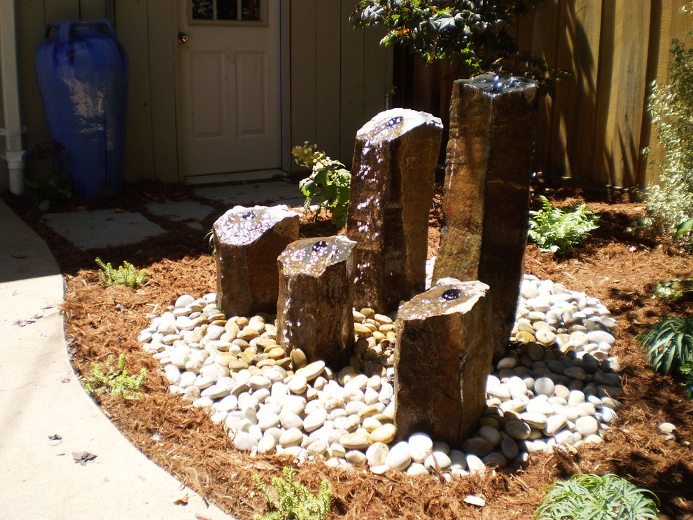 Waterfeatures, basalite pillar water feature with mulch and native ...