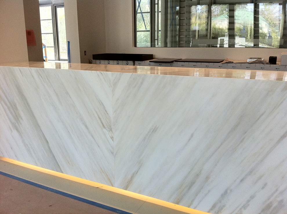 bar with suspended counter top book matched calacatta marble ...