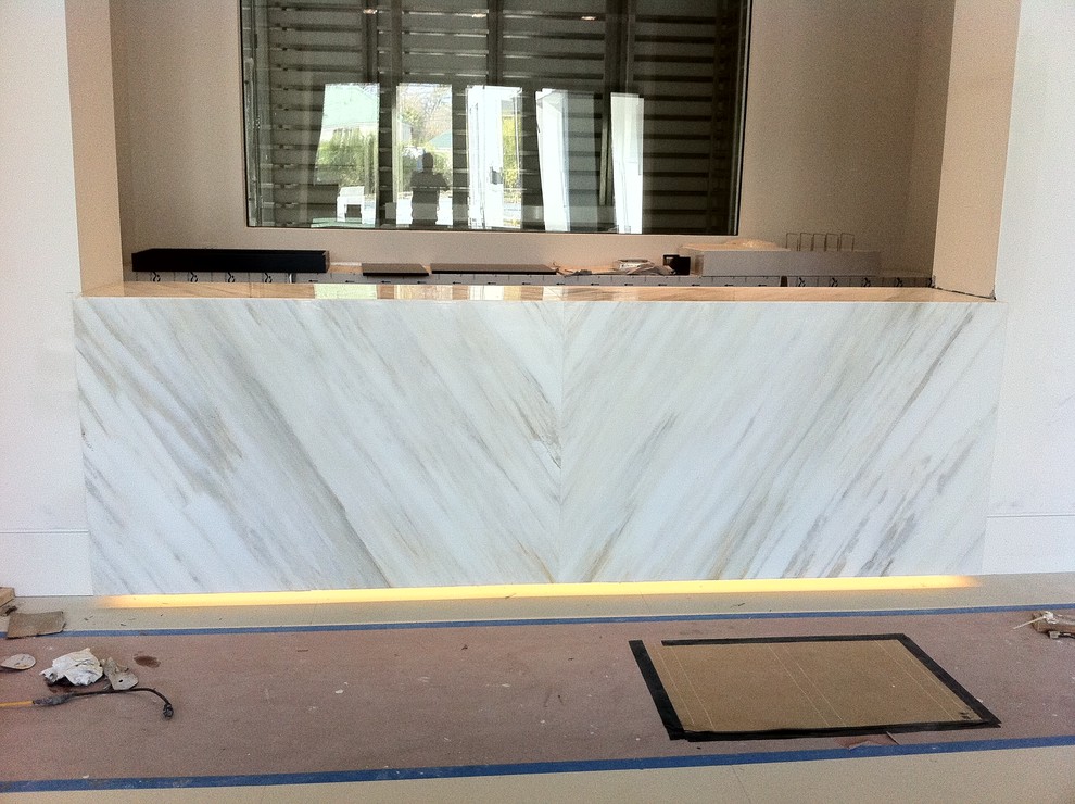 bar with suspended counter top book matched calacatta marble ...