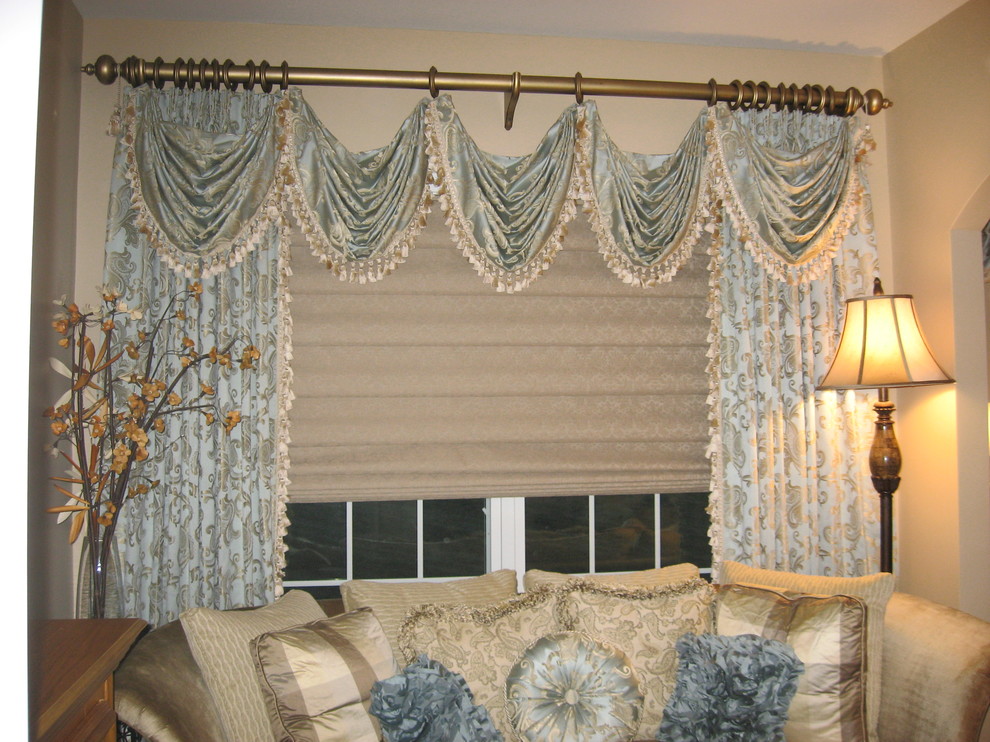 Stationary Drapery Panels with Swag Overlays on Decorative Wood Poles ...