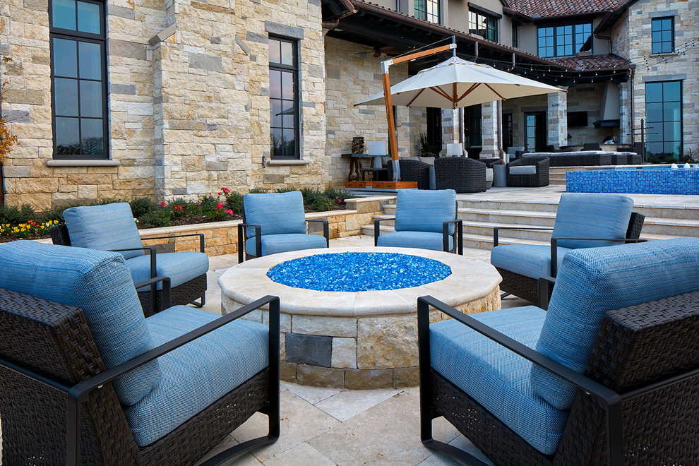 Backyard Stone Fire Pit With Woven, Upholstered Arm Chairs ...
