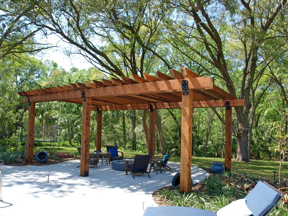 Backyard Tudor revival landscape along a natural area with a stream ...