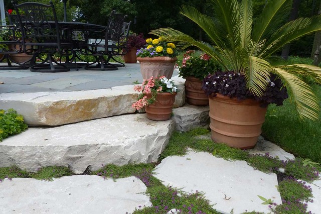 Closeup of outcropping stone steps to elevated bluestone patio ...