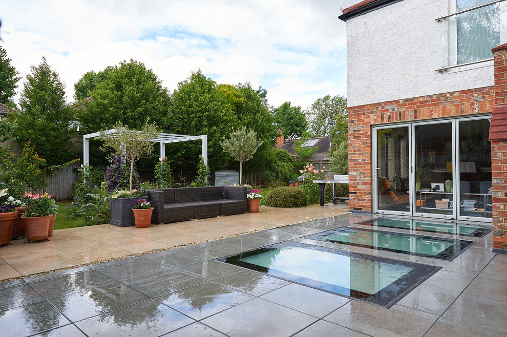 Patio with walk on glass over basement ceiling - Modern - Patio ...