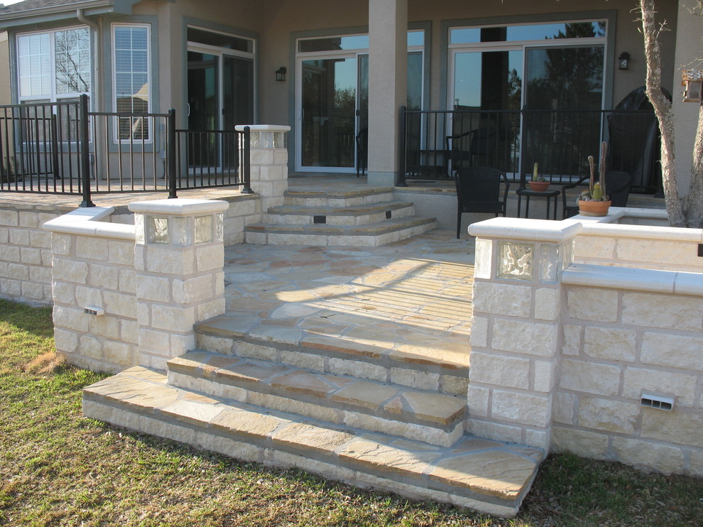 Modern flagstone patio w/ limestone walls, lighted glass block columns ...
