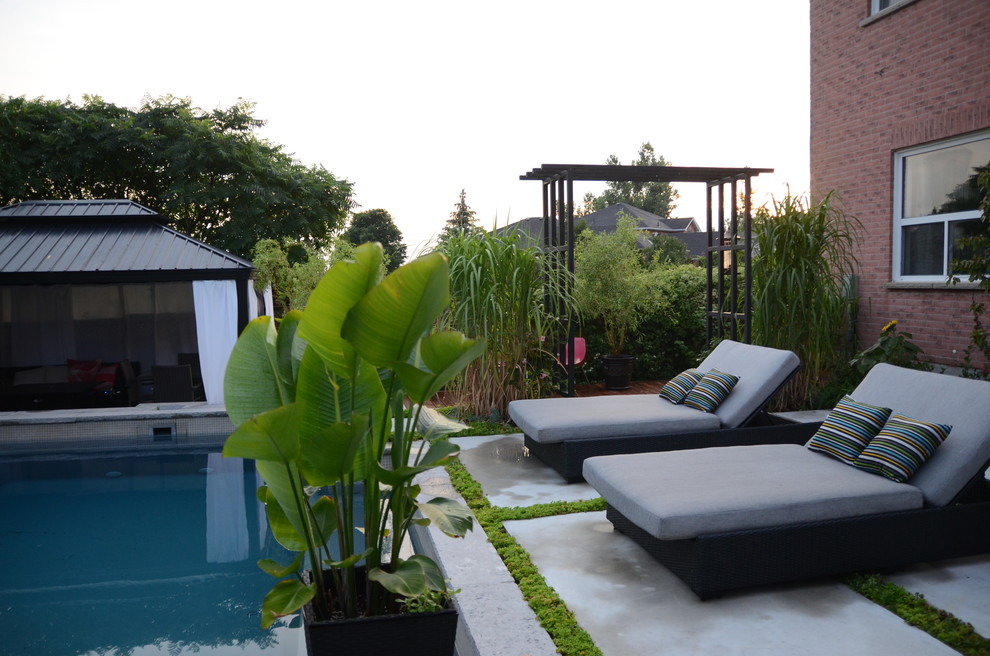 Modern Landscape with Fiberglass Pool, slab patio, water feature and ...