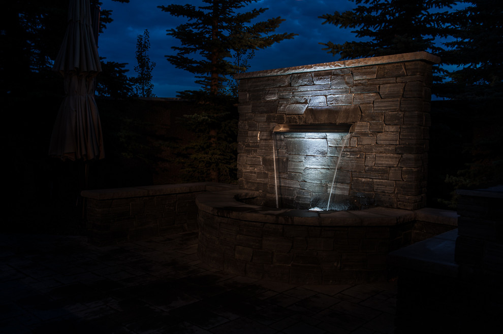 Natural stone water wall and outdoor kitchen - Transitional - Patio ...