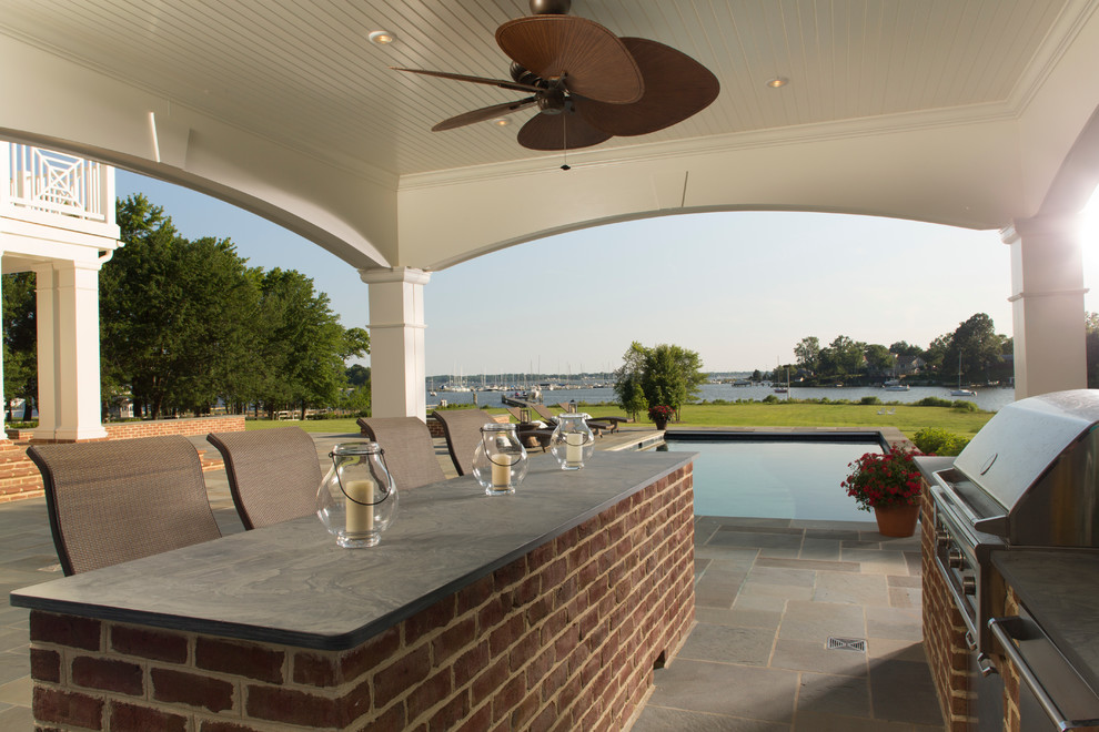 Outdoor BBQ pavillion with seating area and water views - Traditional ...