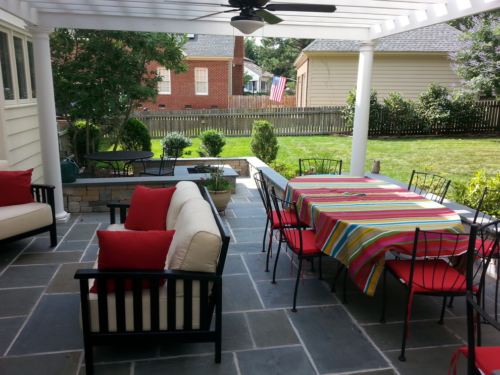 Outdoor kitchen and pergola with a bluestone patio - Traditional ...